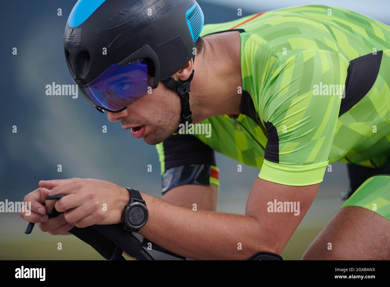 triathlon athlete riding professional racing bike at workout on curvy ...