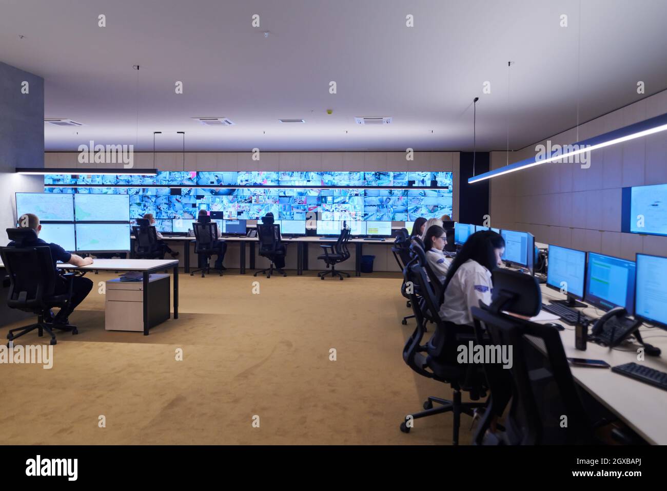 Group of Security data center operators working in a CCTV monitoring ...
