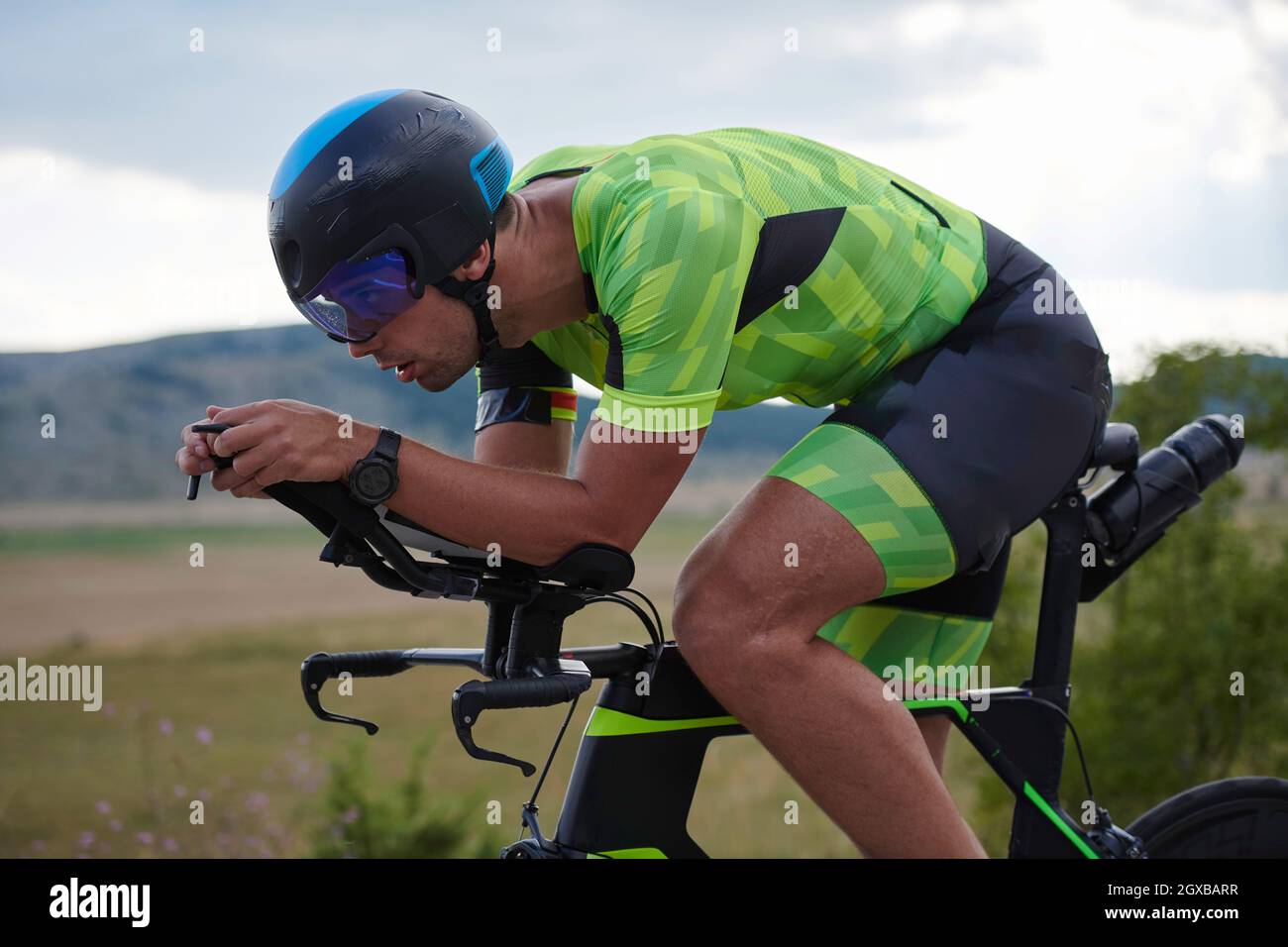 triathlon athlete riding professional racing bike at workout on curvy ...