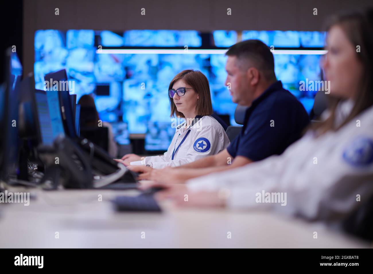 Group of Security data center operators working in a CCTV monitoring ...