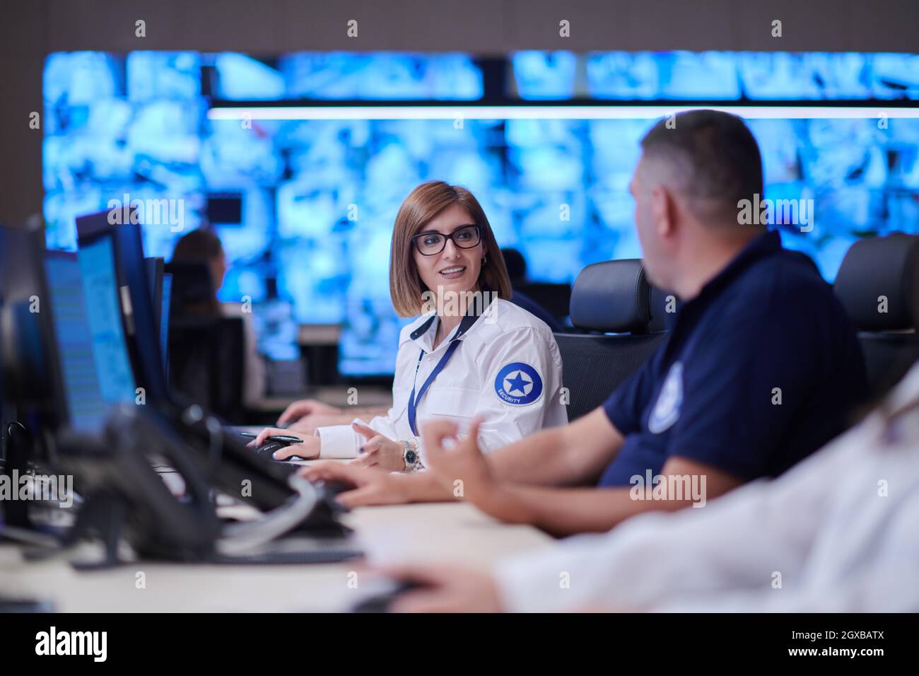 Group of Security data center operators working in a CCTV monitoring ...
