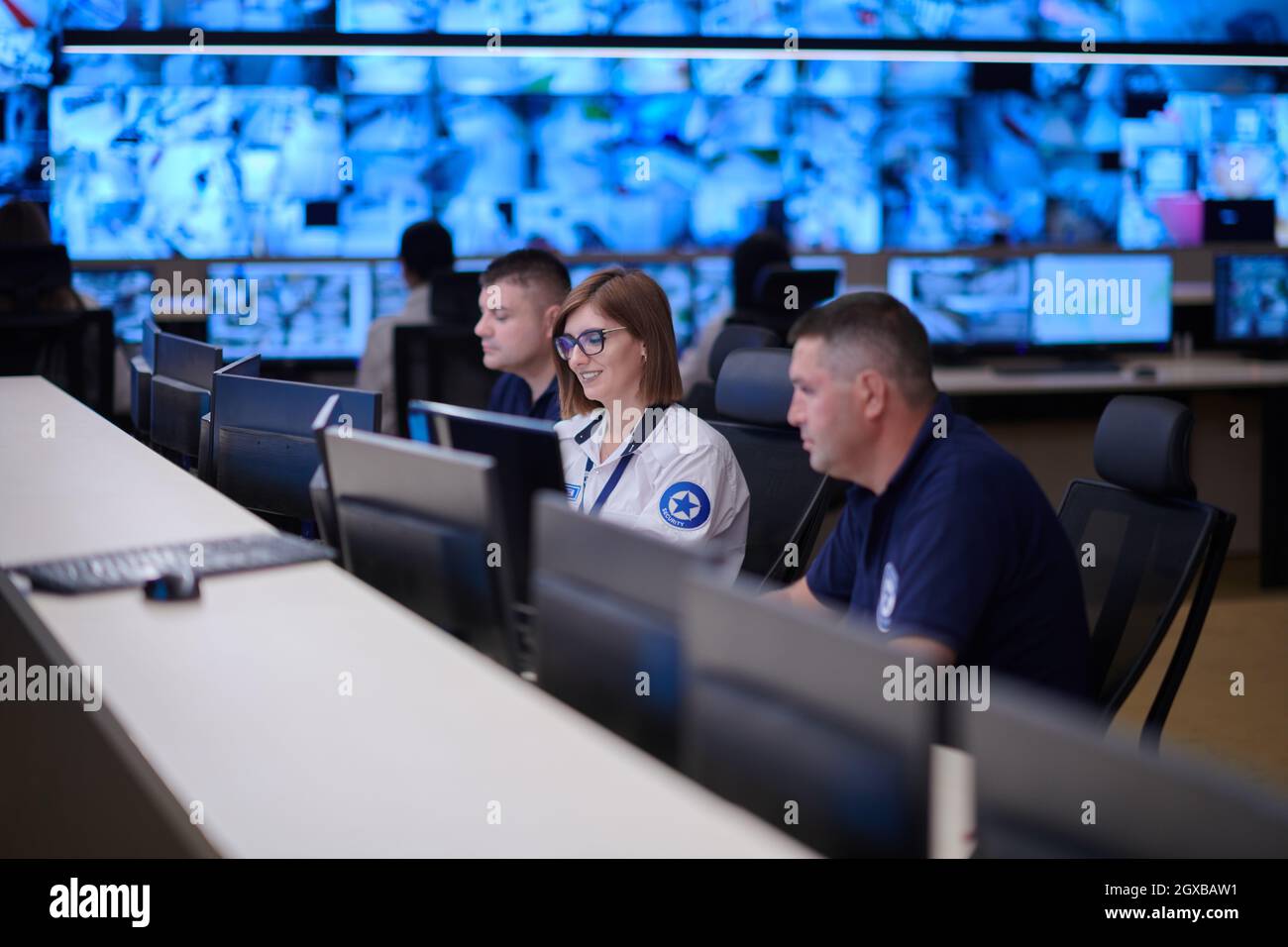 Group of Security data center operators working in a CCTV monitoring ...