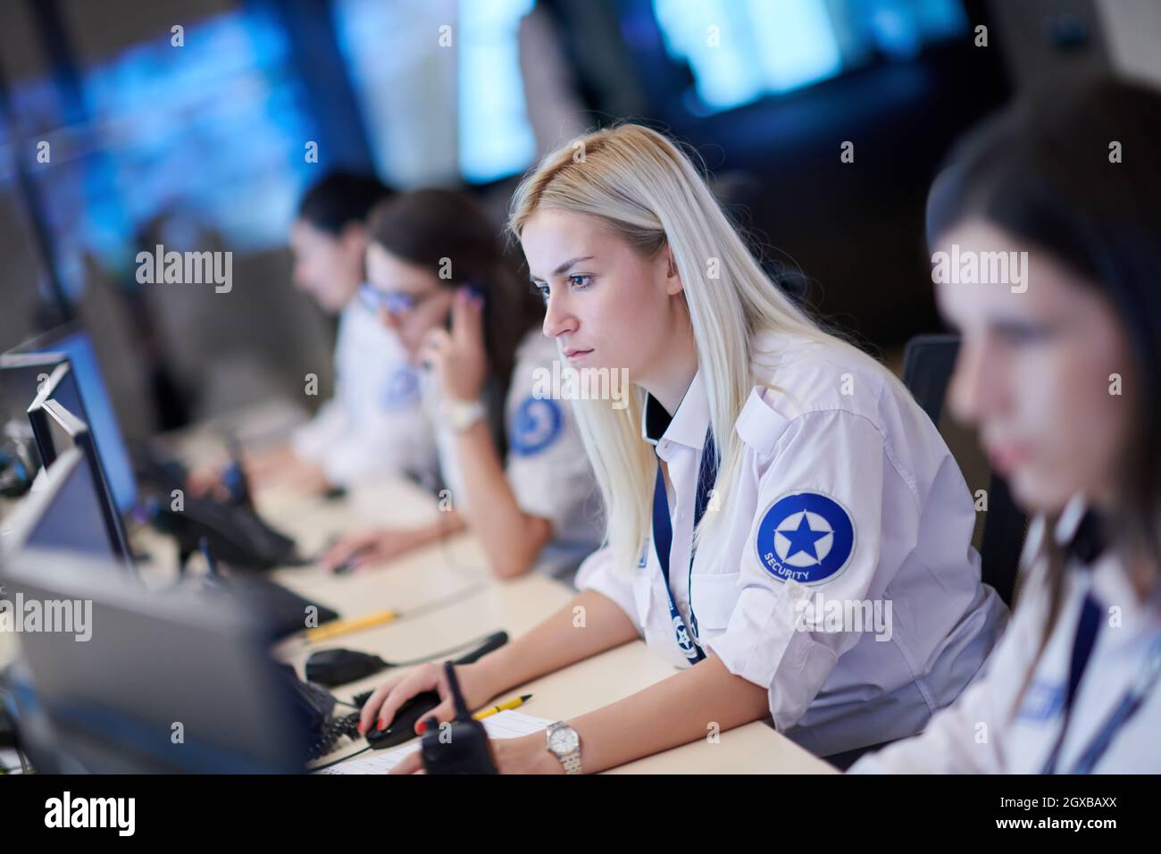 Female security operator working in a data system control room offices ...