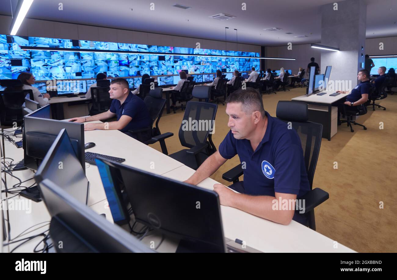 Group of Security data center operators working in a CCTV monitoring ...