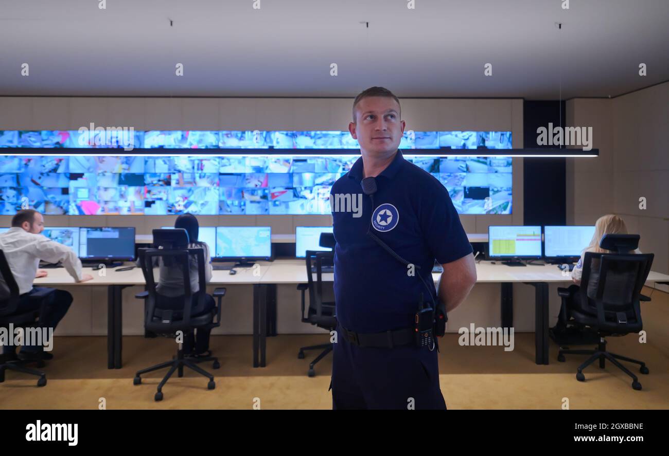 portrait of young male security operator working in a data system ...