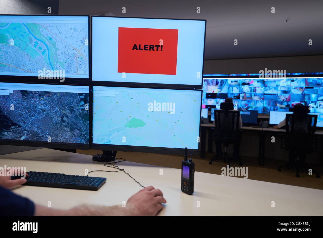 Male security operator working in a data system control room offices ...