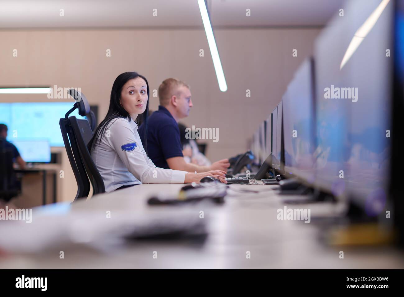 Female Security Operator Working In A Data System Control Room Offices Technical Operator