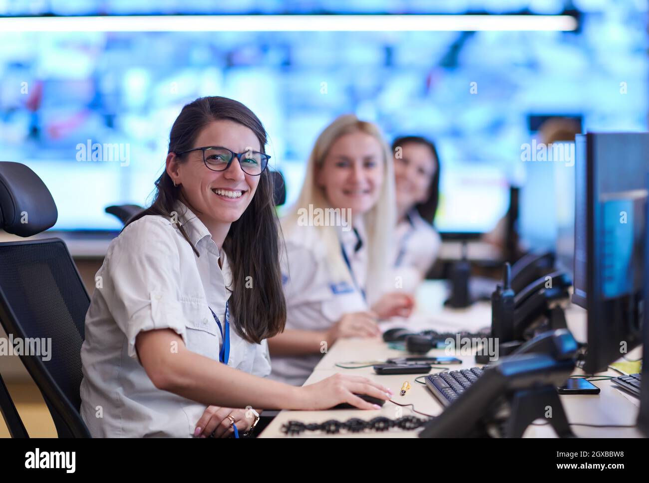 Female security operator working in a data system control room offices Technical Operator ...
