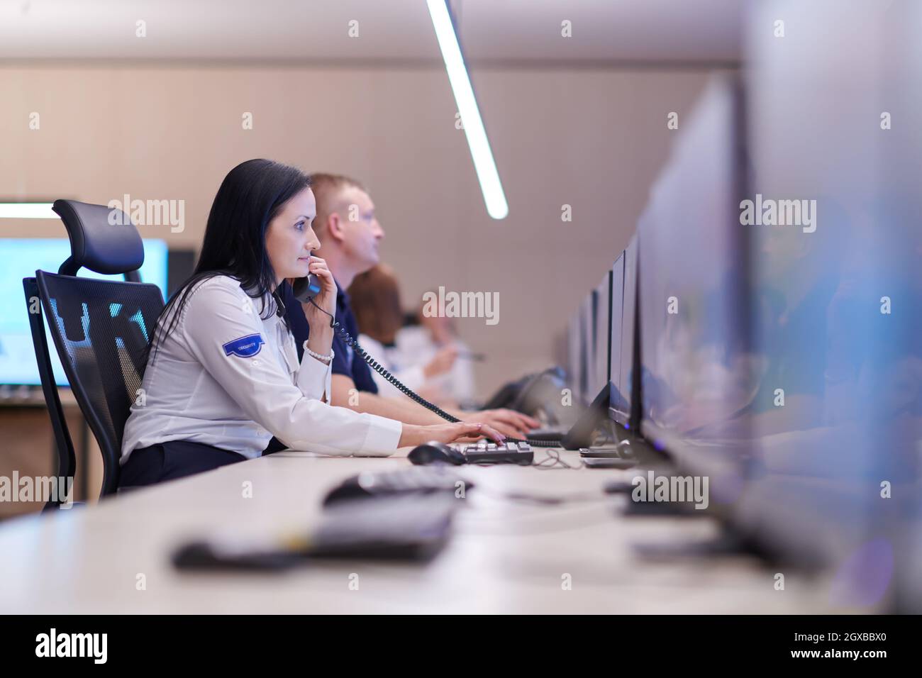 Group of Security data center operators working in a CCTV monitoring ...