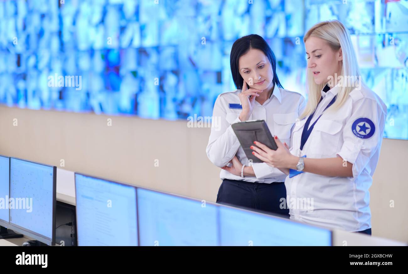 group of female security operators working in a data system control ...