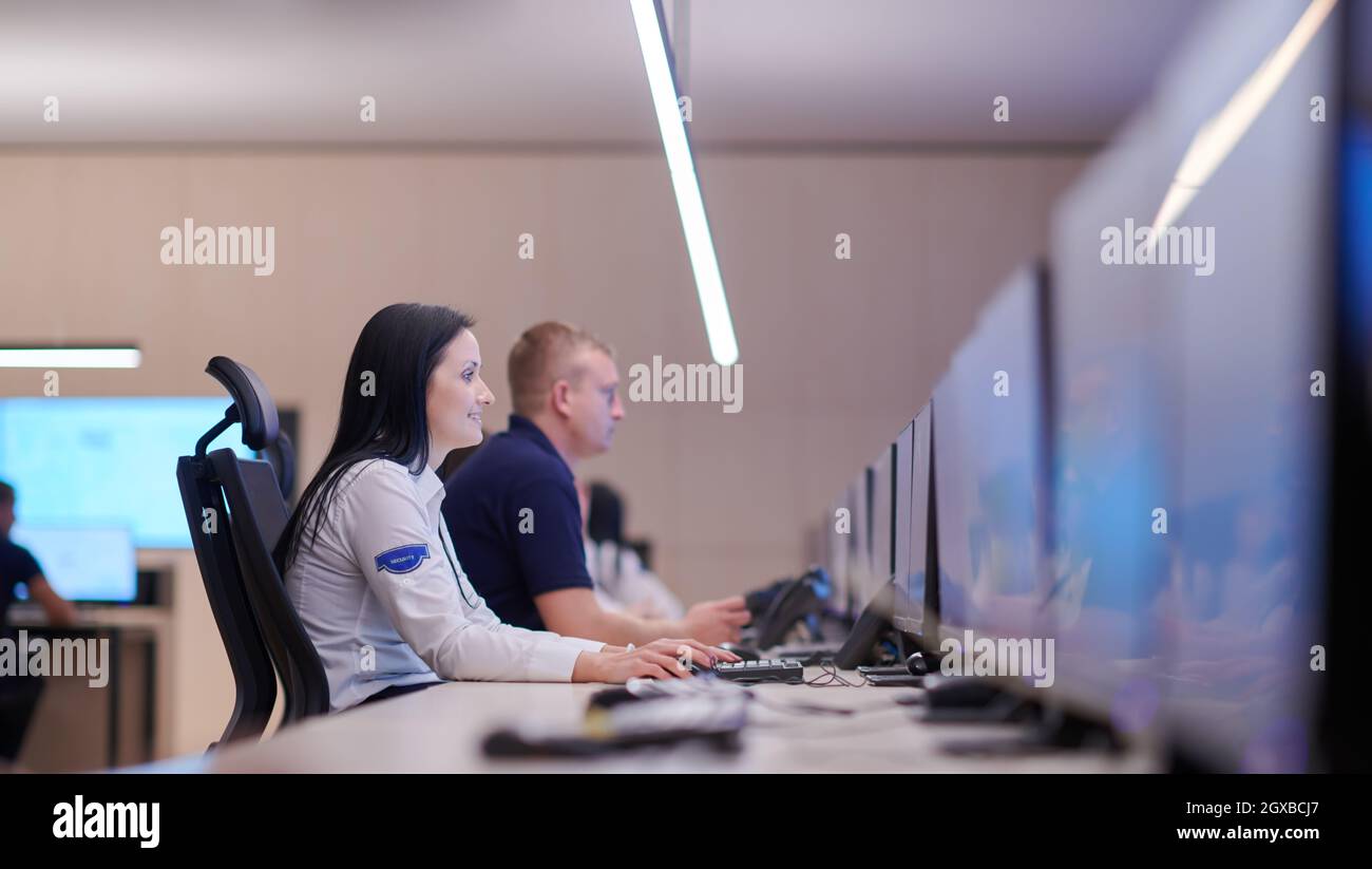 Group of Security data center operators working in a CCTV monitoring ...