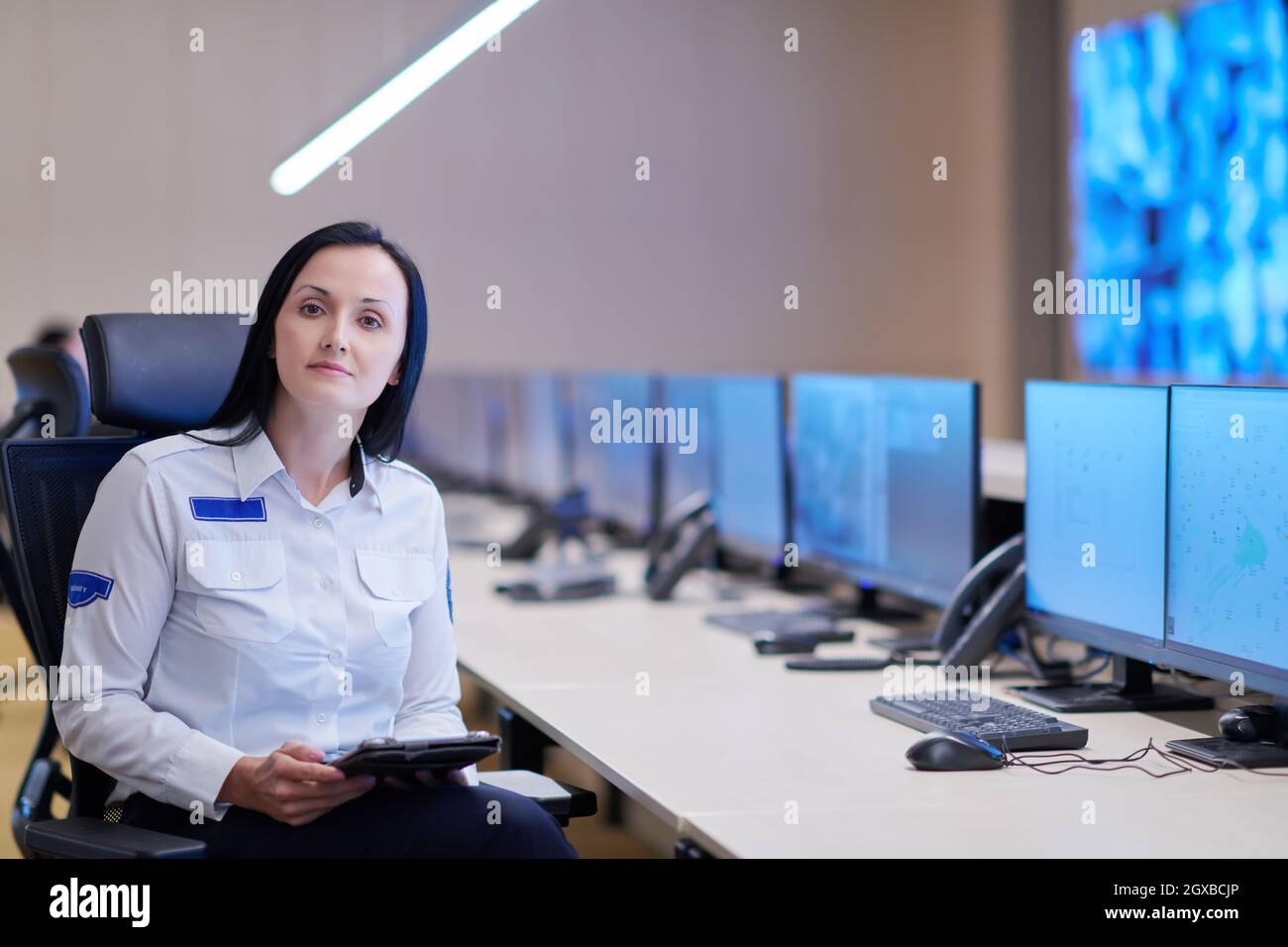 portrait of female security operator while working in a data system ...