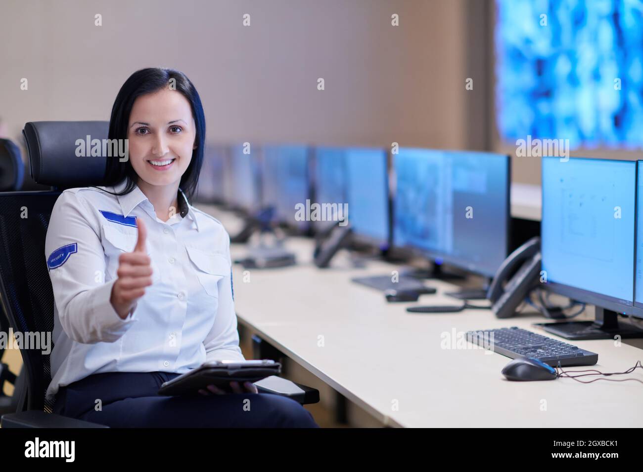 portrait of female security operator while working in a data system ...