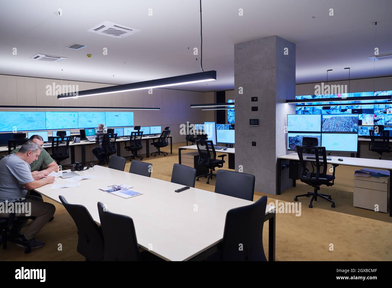 Group of Security data center operators working in a CCTV monitoring ...