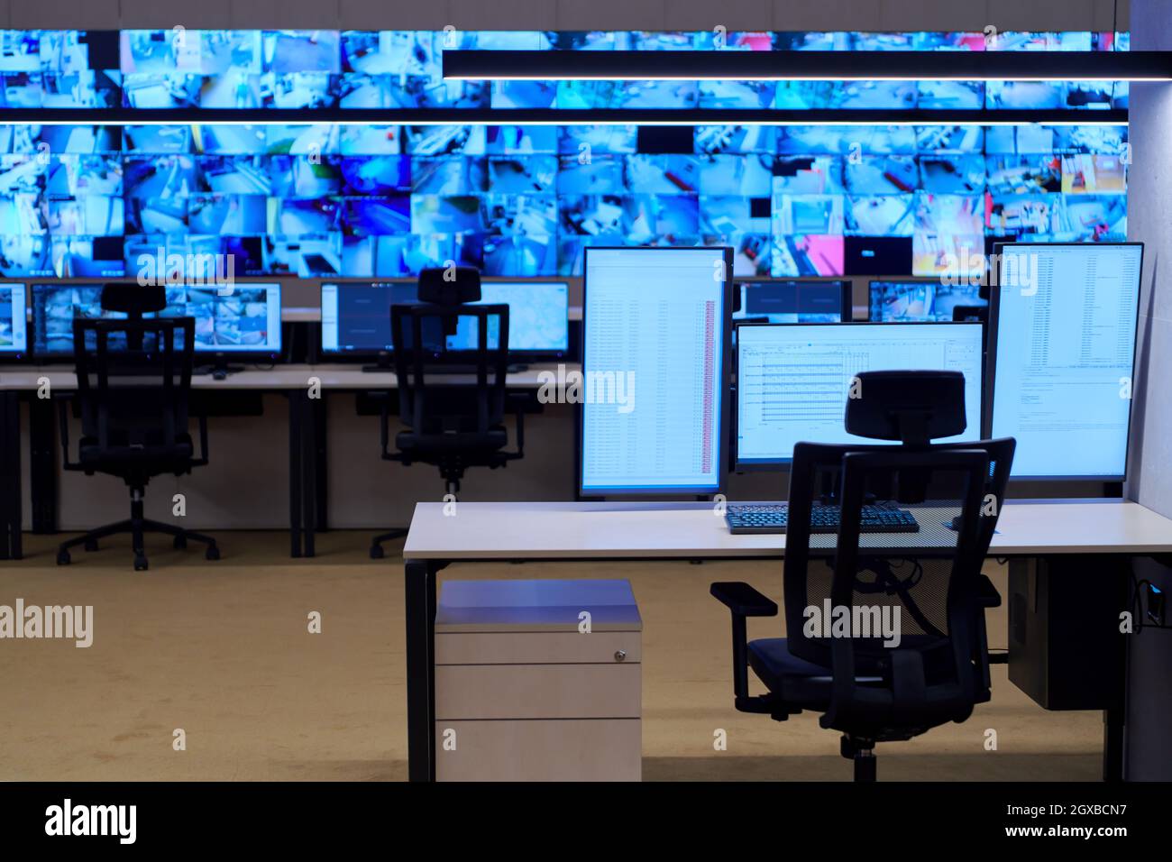 Empty interior of big modern security system control room, workstation ...