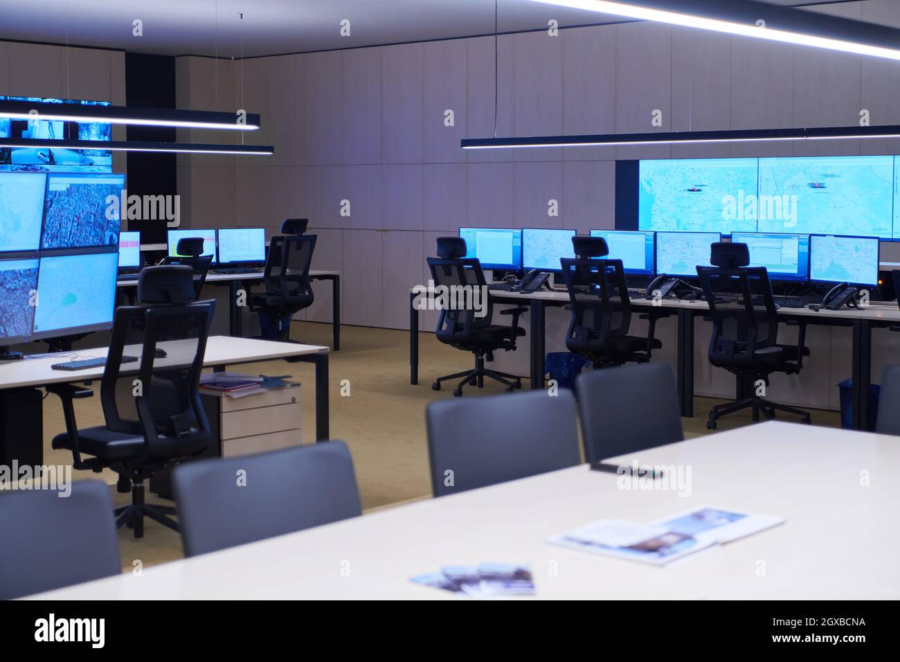 Empty interior of big modern security system control room, workstation ...