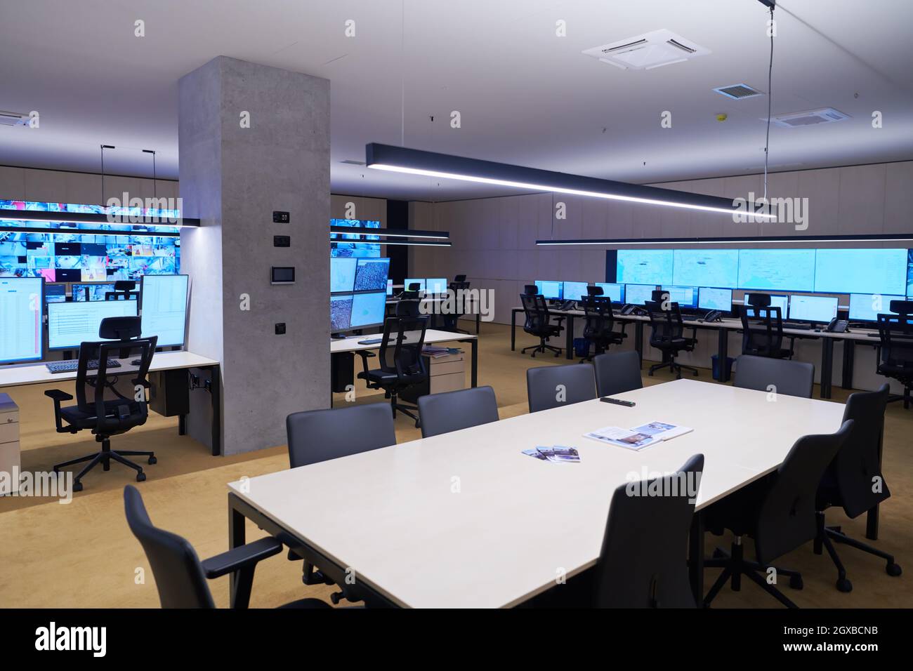 Empty interior of big modern security system control room, workstation ...