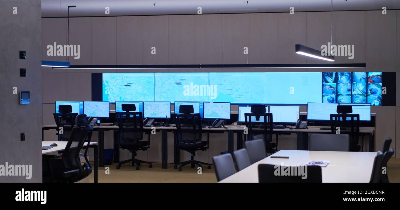 Empty interior of big modern security system control room, workstation ...