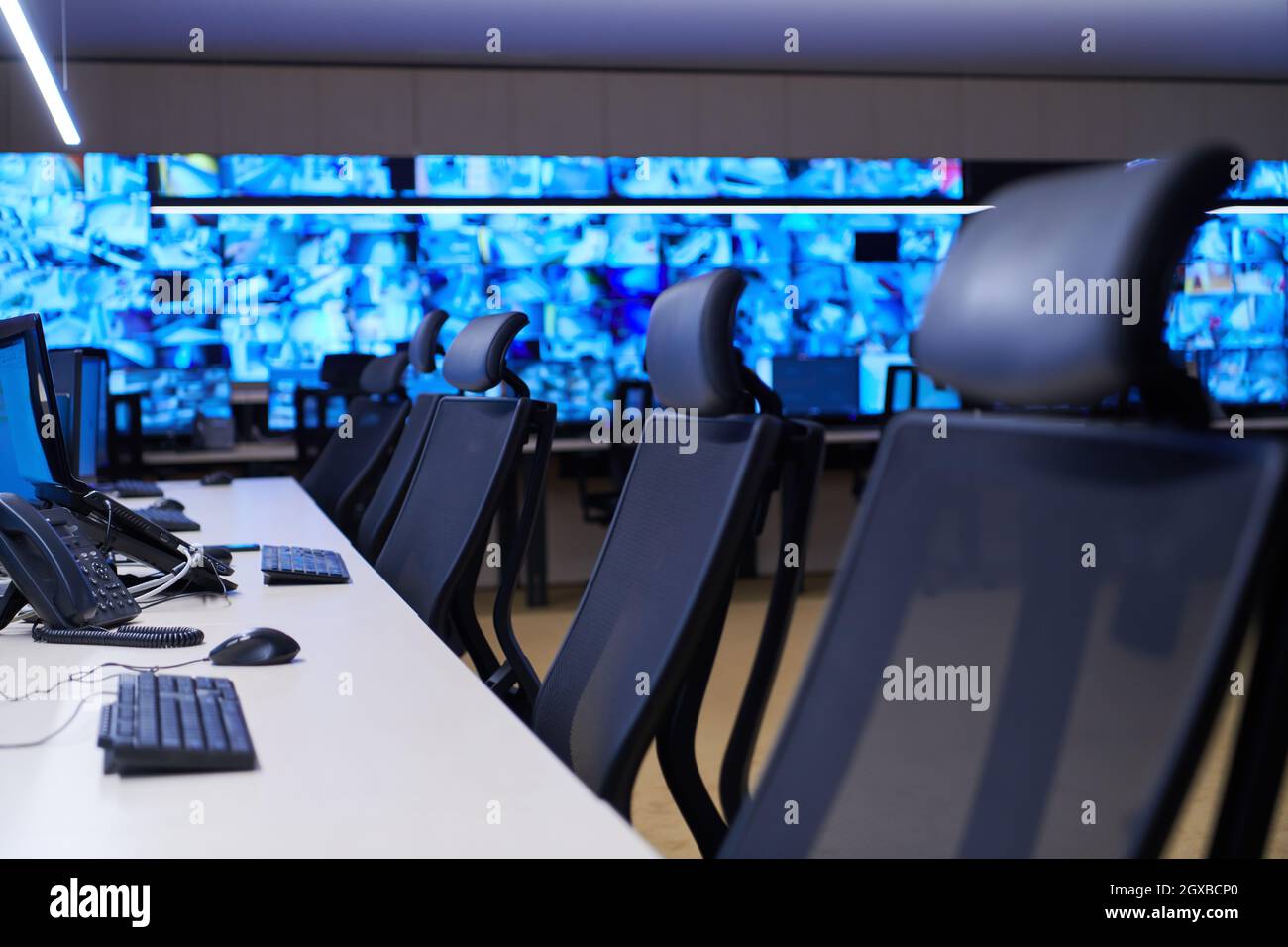 Empty interior of big modern security system control room, workstation ...
