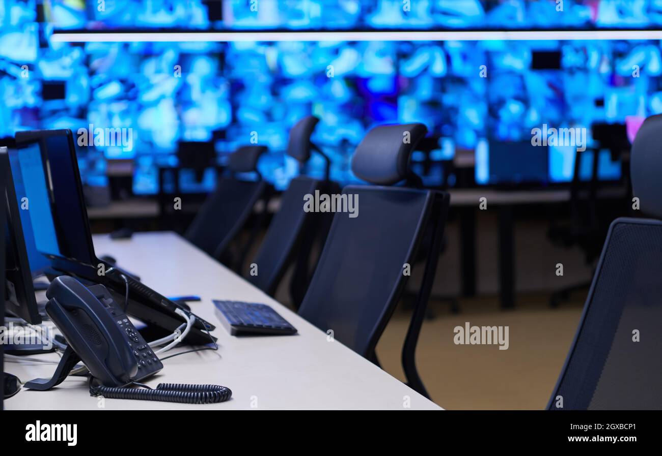 Empty interior of big modern security system control room, workstation ...