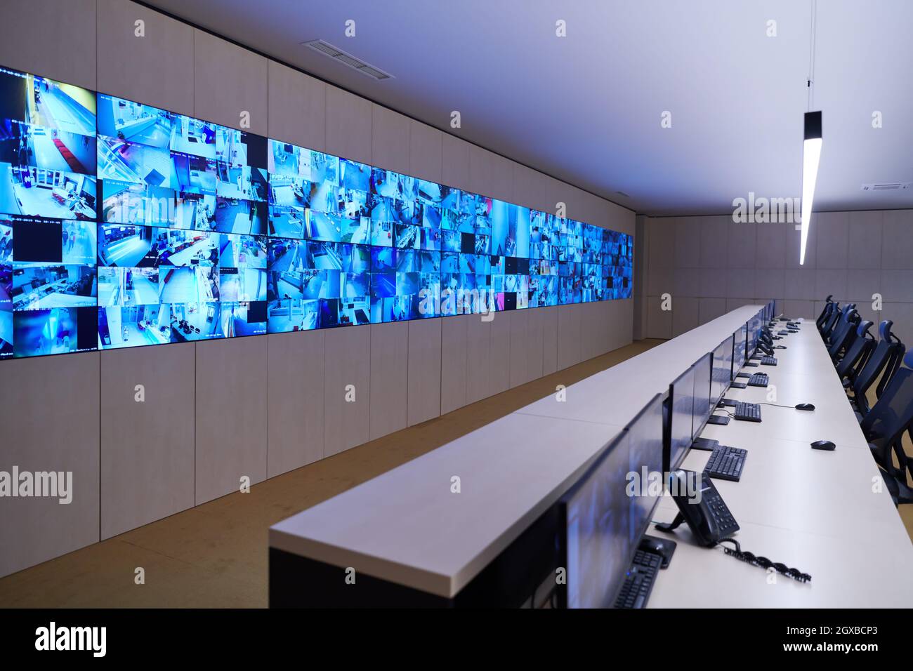 Empty interior of big modern security system control room, workstation ...