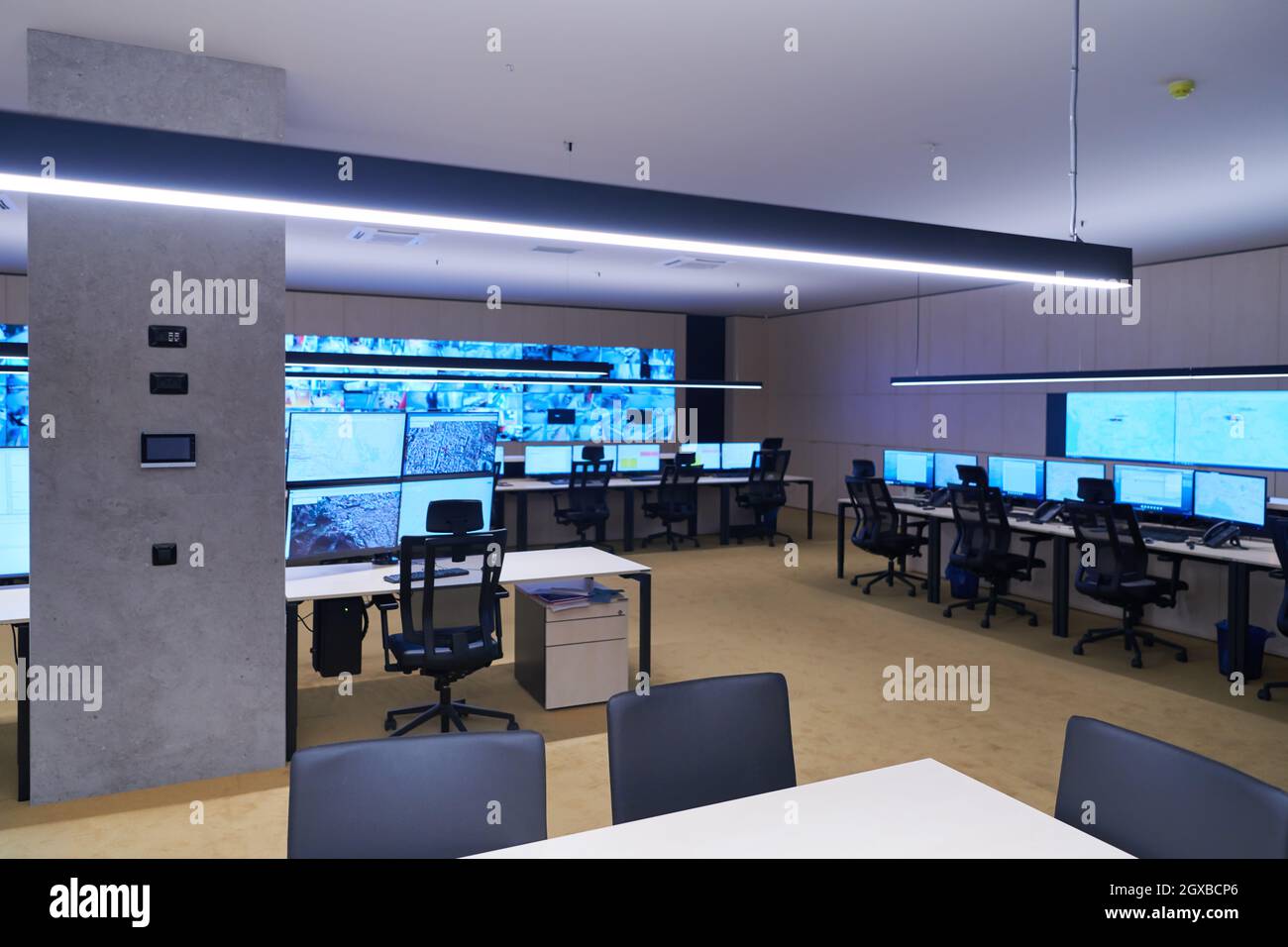 Empty interior of big modern security system control room, workstation ...