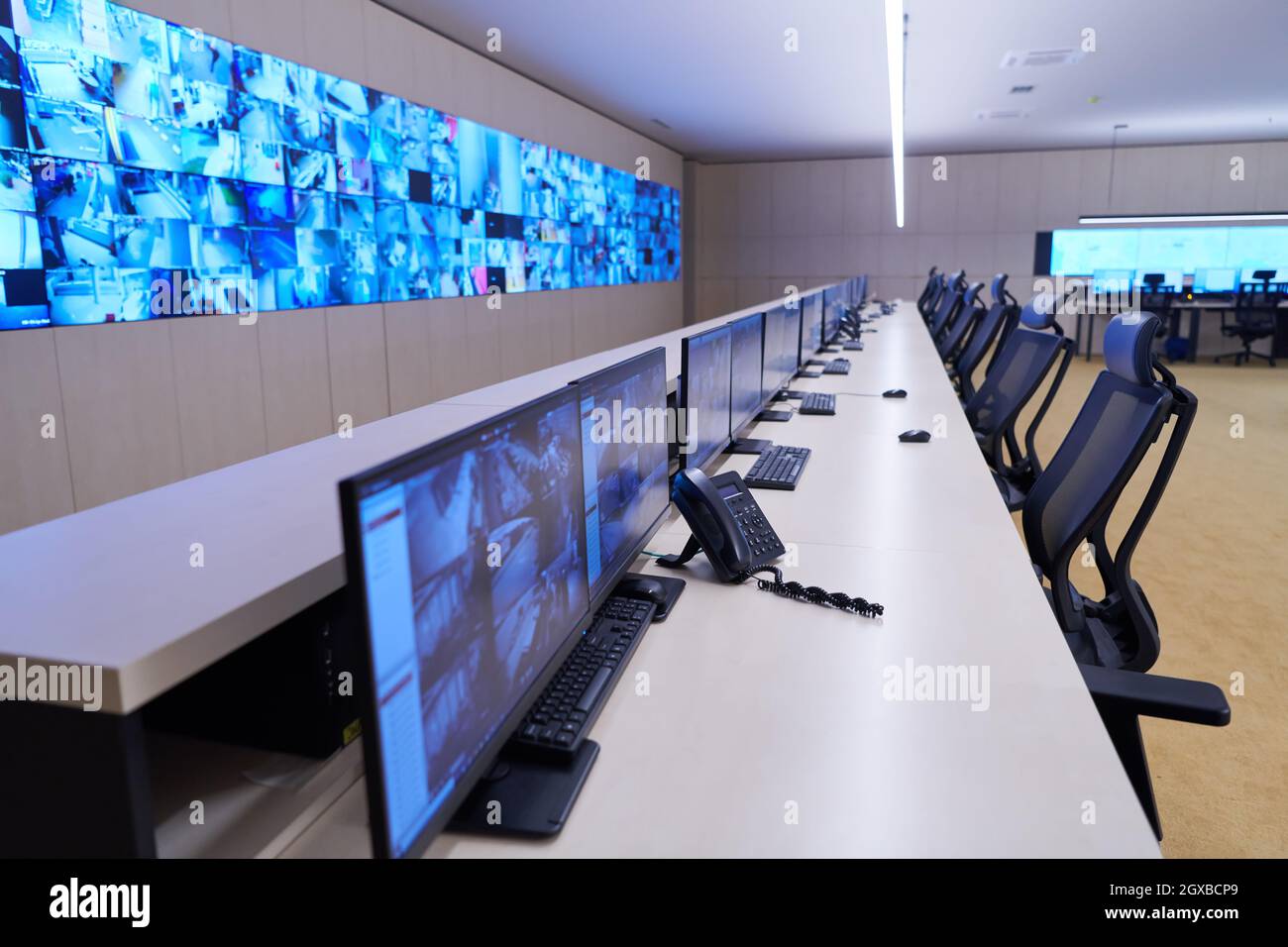 Empty interior of big modern security system control room, workstation ...