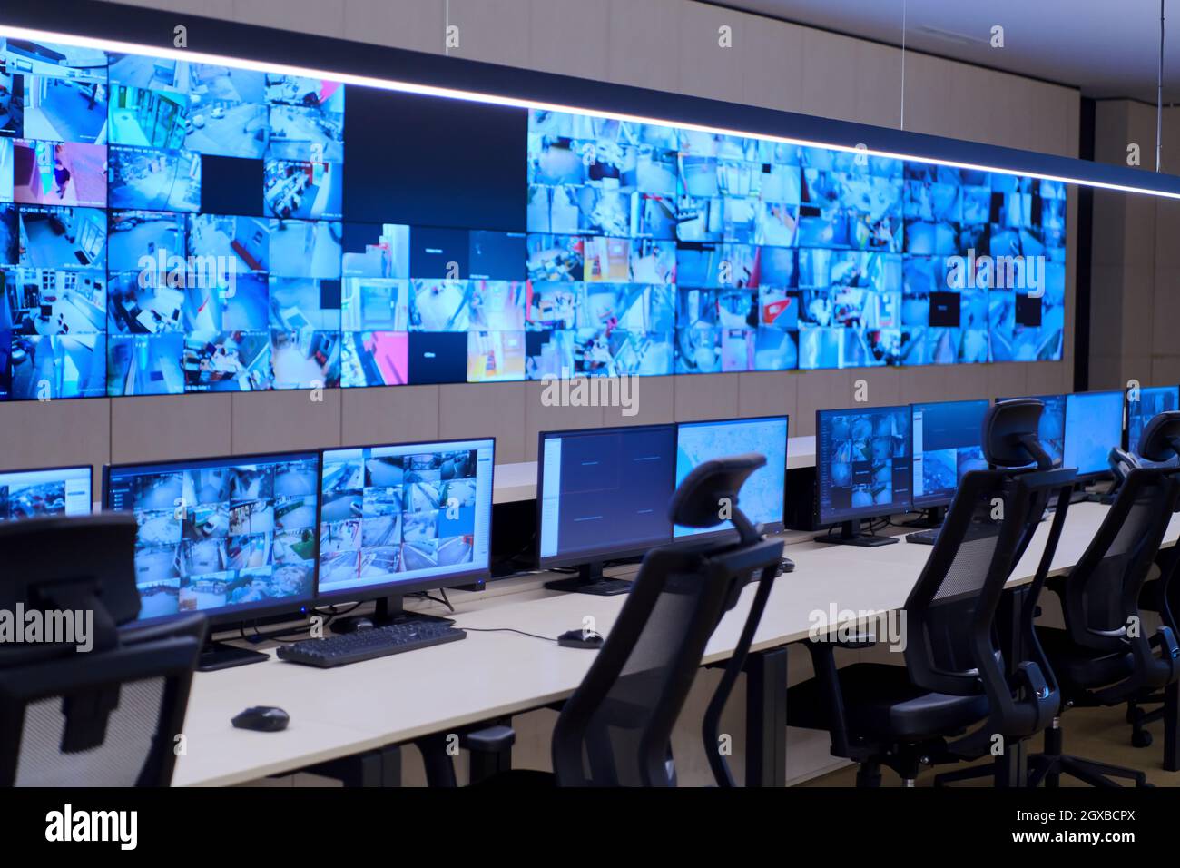 Empty interior of big modern security system control room, workstation ...
