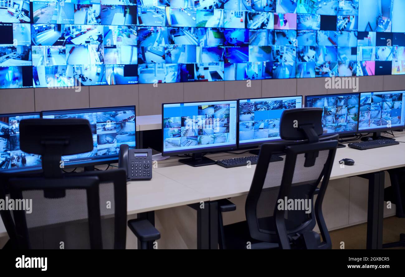 Empty interior of big modern security system control room, workstation ...