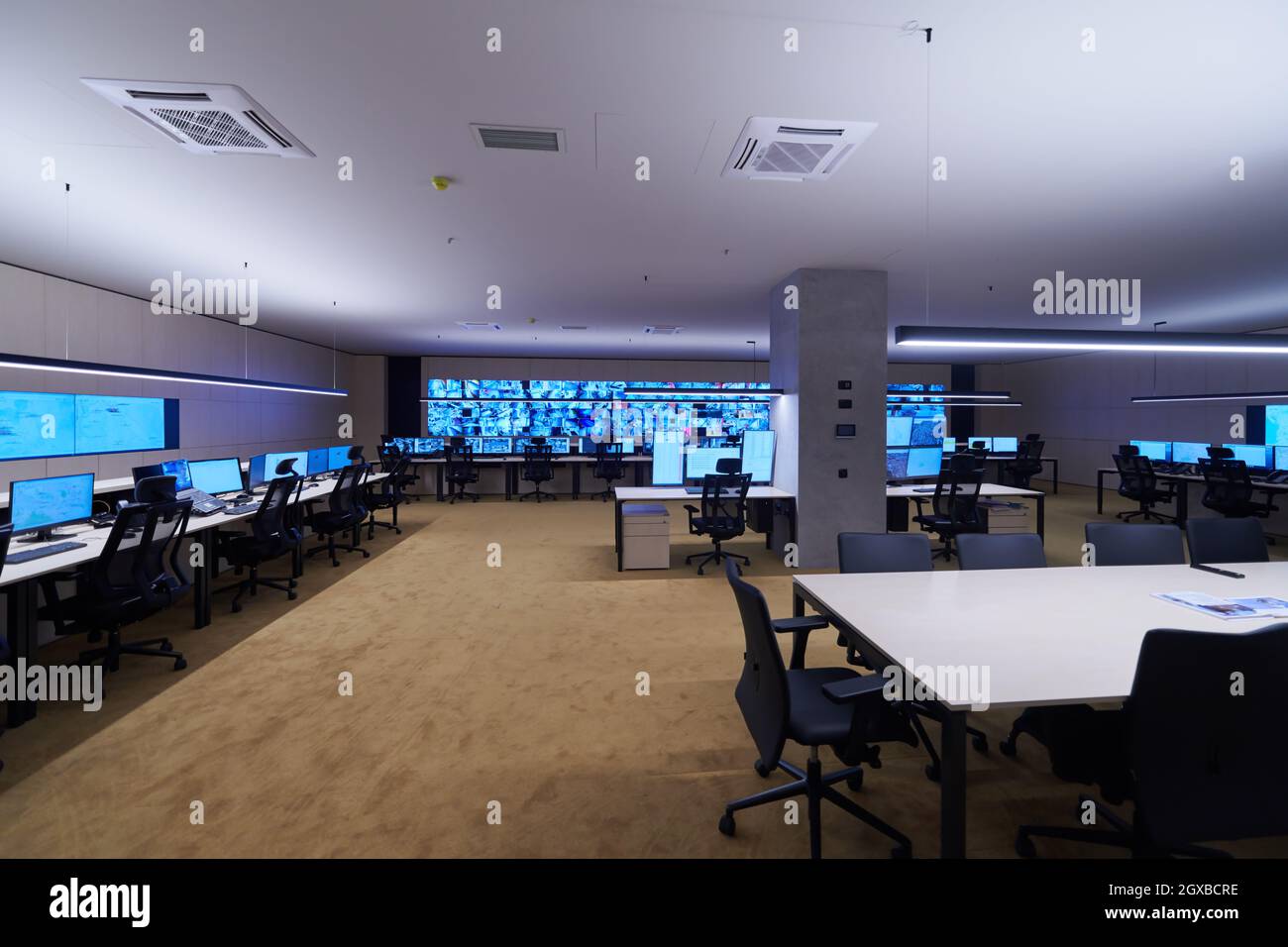 Empty interior of big modern security system control room, workstation ...