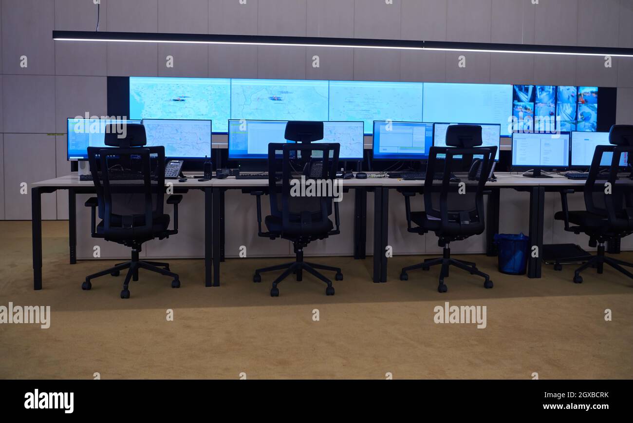 Empty interior of big modern security system control room, workstation ...