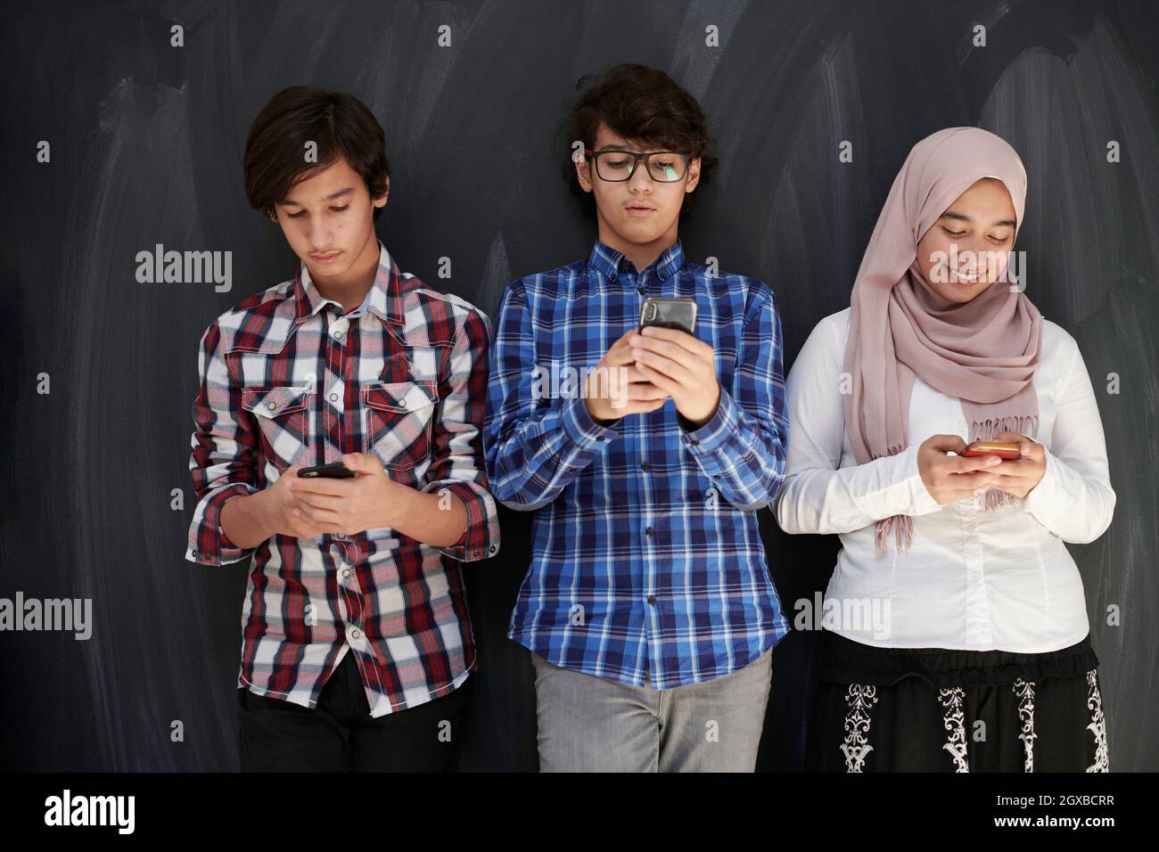 arab teenagers group using smart phones for social media networking ...