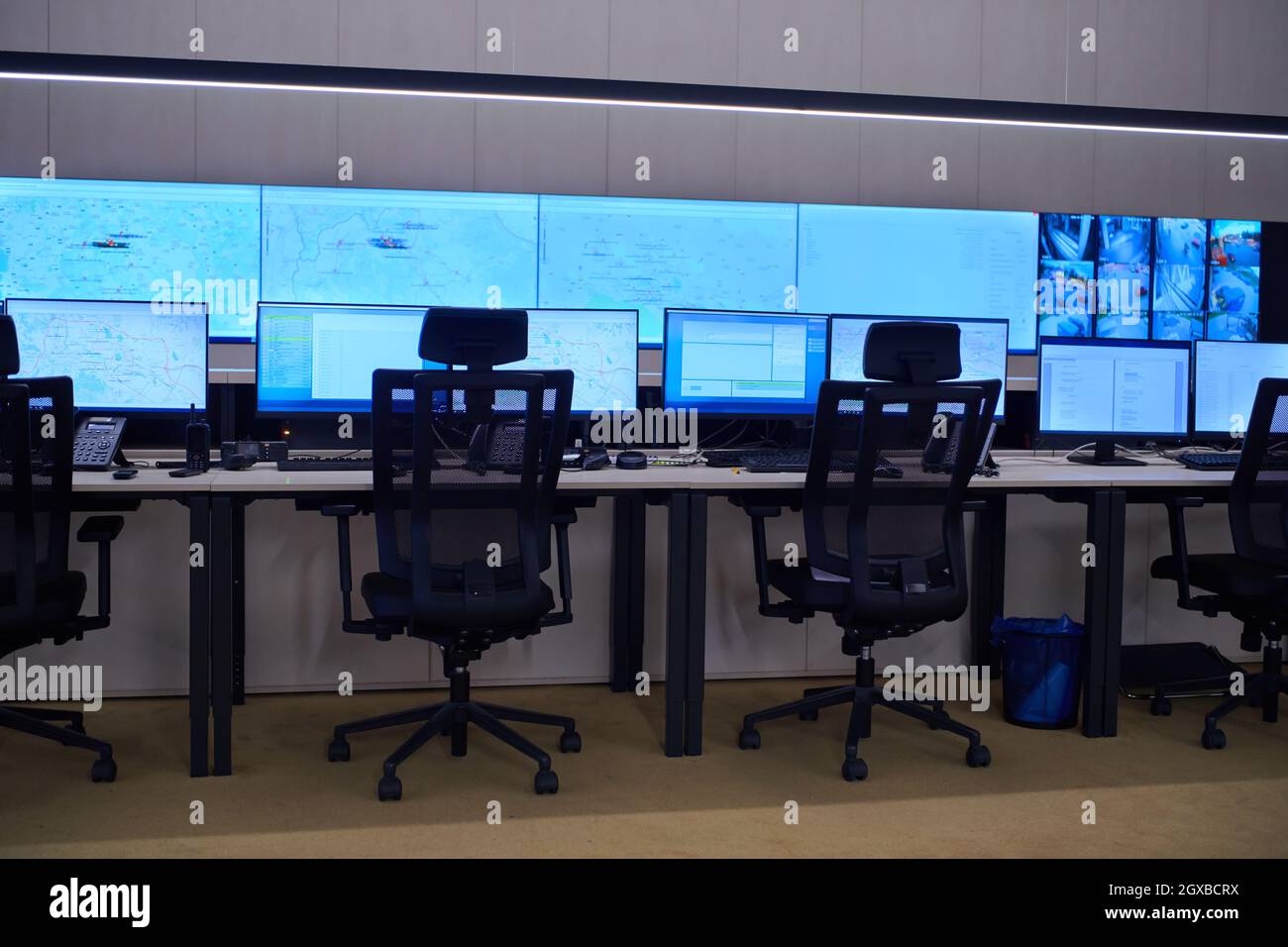 Empty interior of big modern security system control room, workstation ...