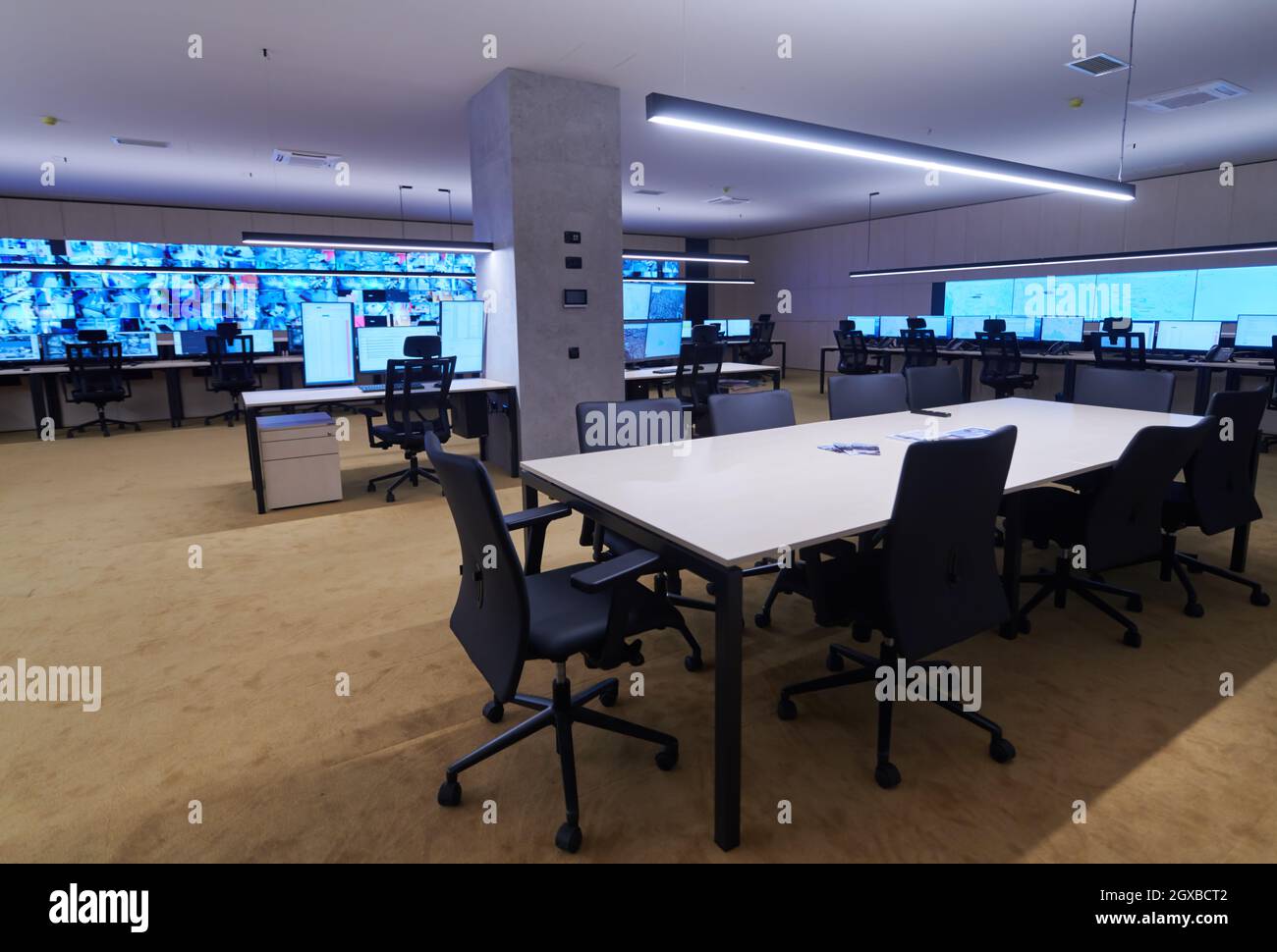 Empty interior of big modern security system control room, workstation ...