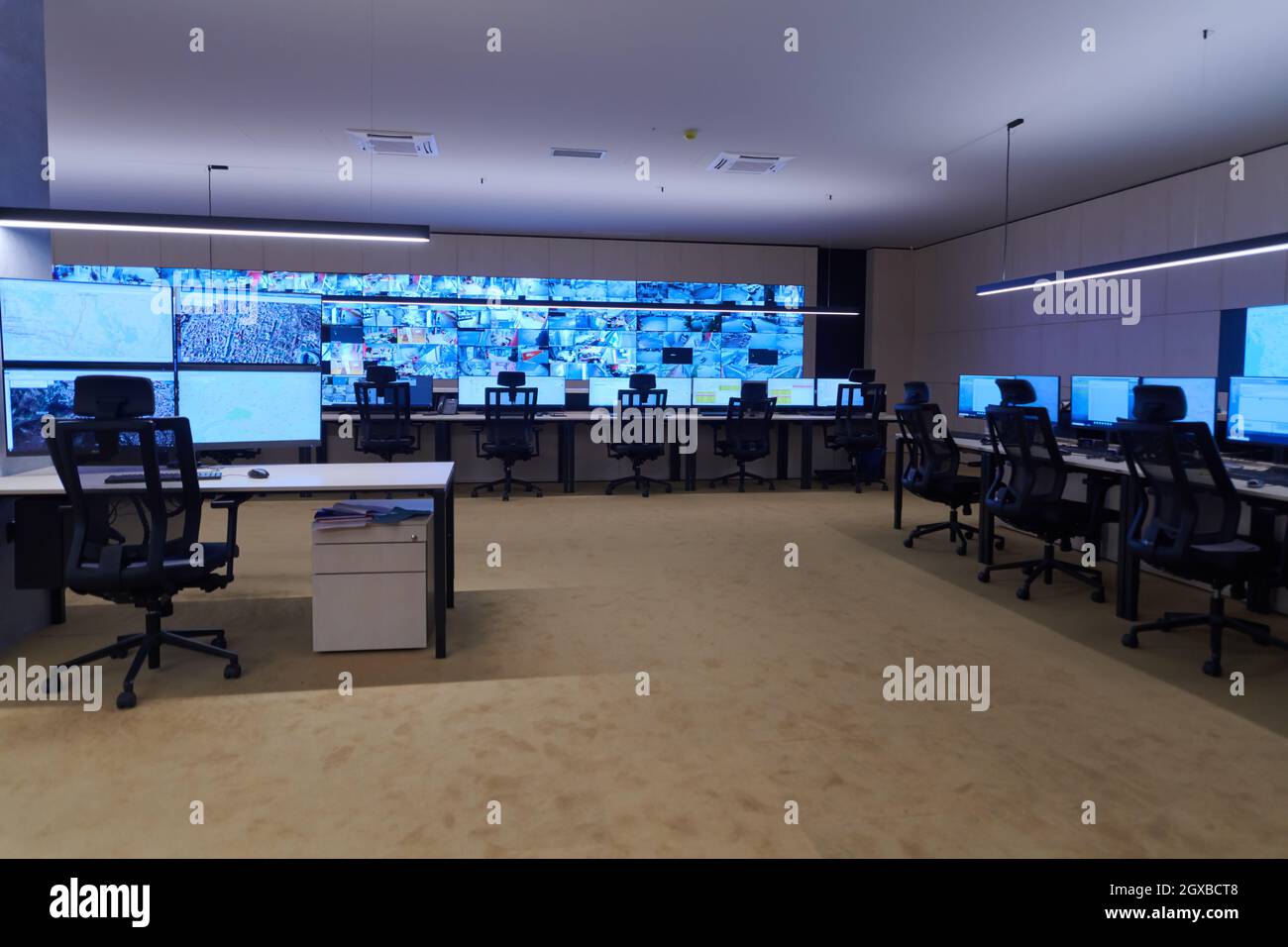 Empty interior of big modern security system control room, workstation with multiple displays ...