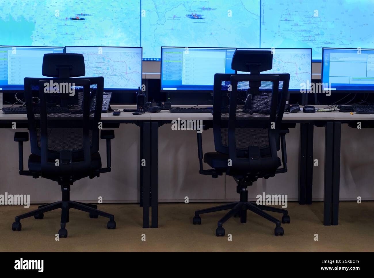 Empty interior of big modern security system control room, workstation ...