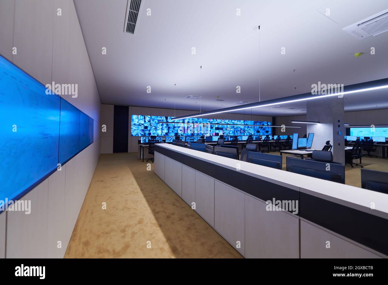 Empty interior of big modern security system control room, workstation ...