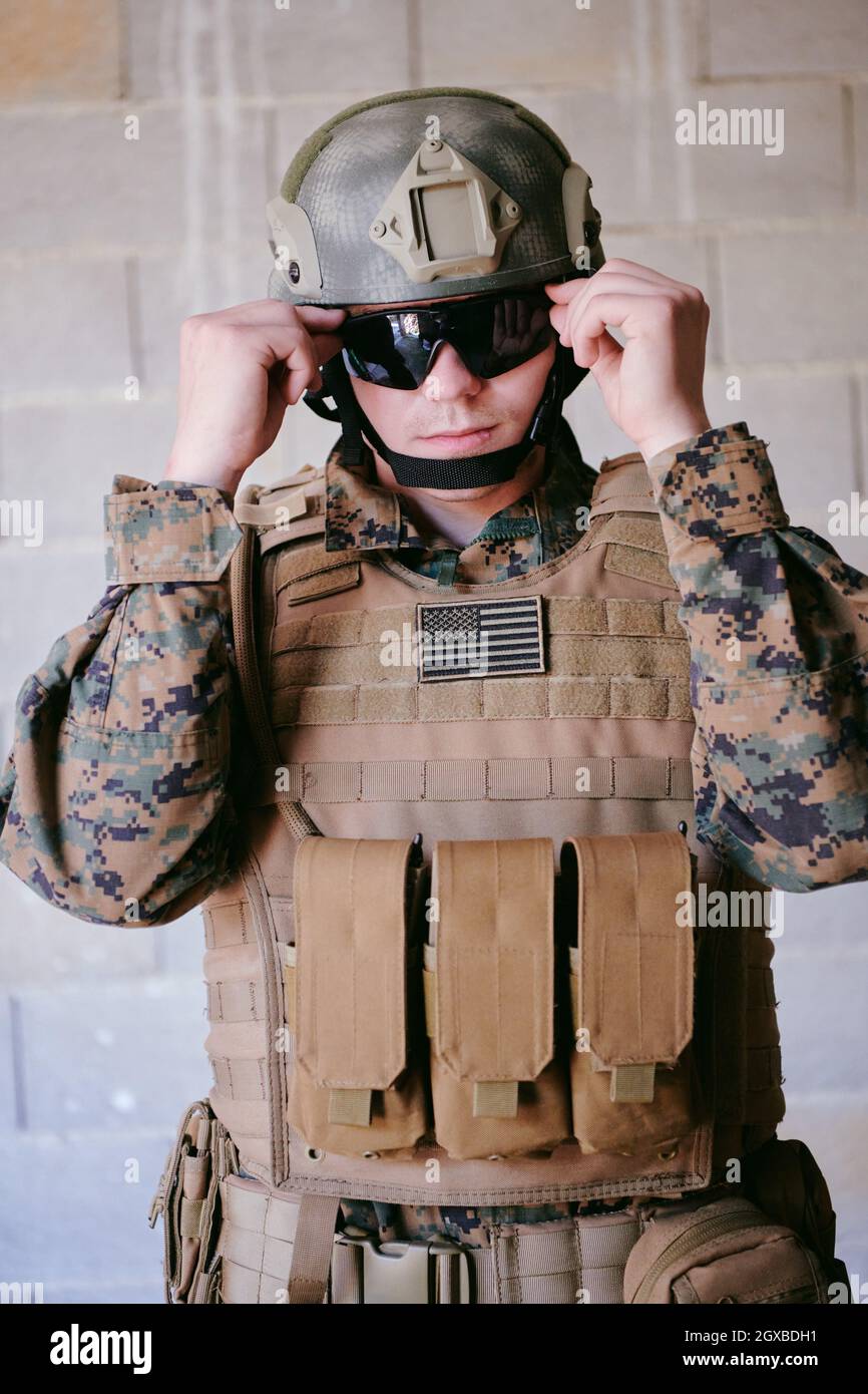 soldier preparing tactical protective and communication gear for action ...