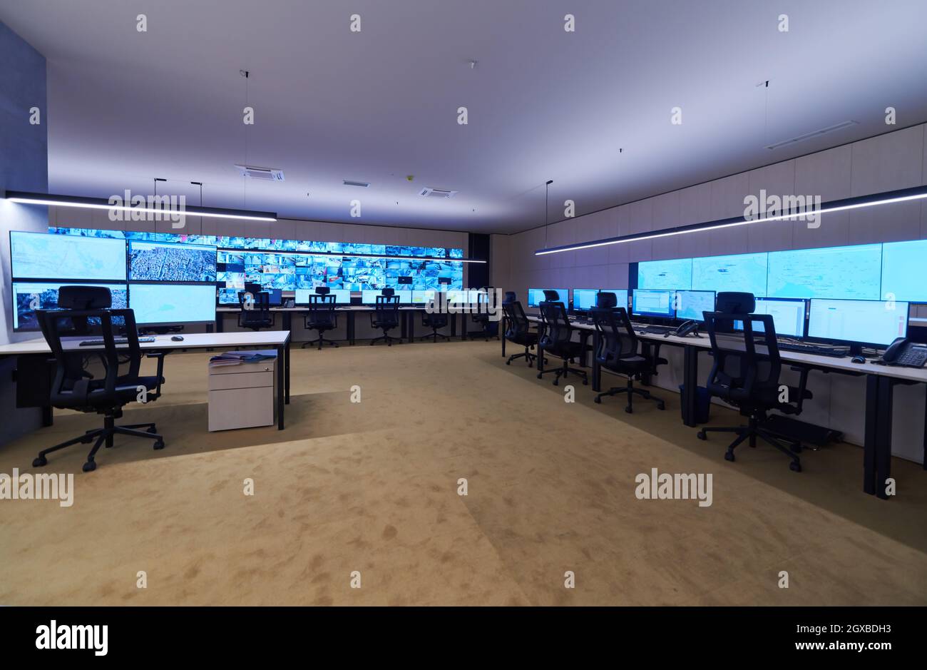 Empty interior of big modern security system control room, workstation ...