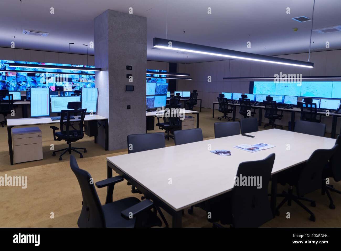 Empty interior of big modern security system control room, workstation ...