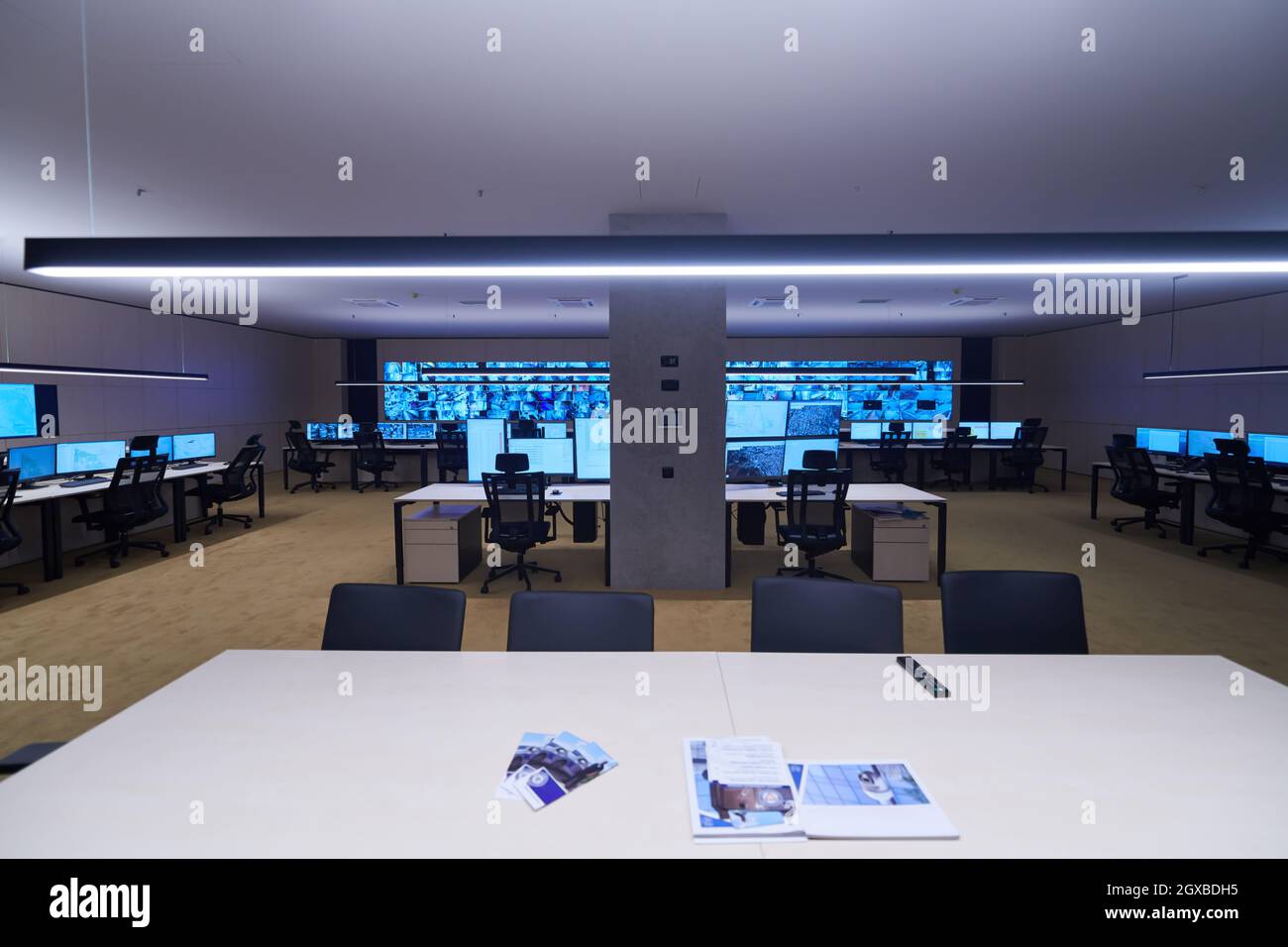 Empty interior of big modern security system control room, workstation ...