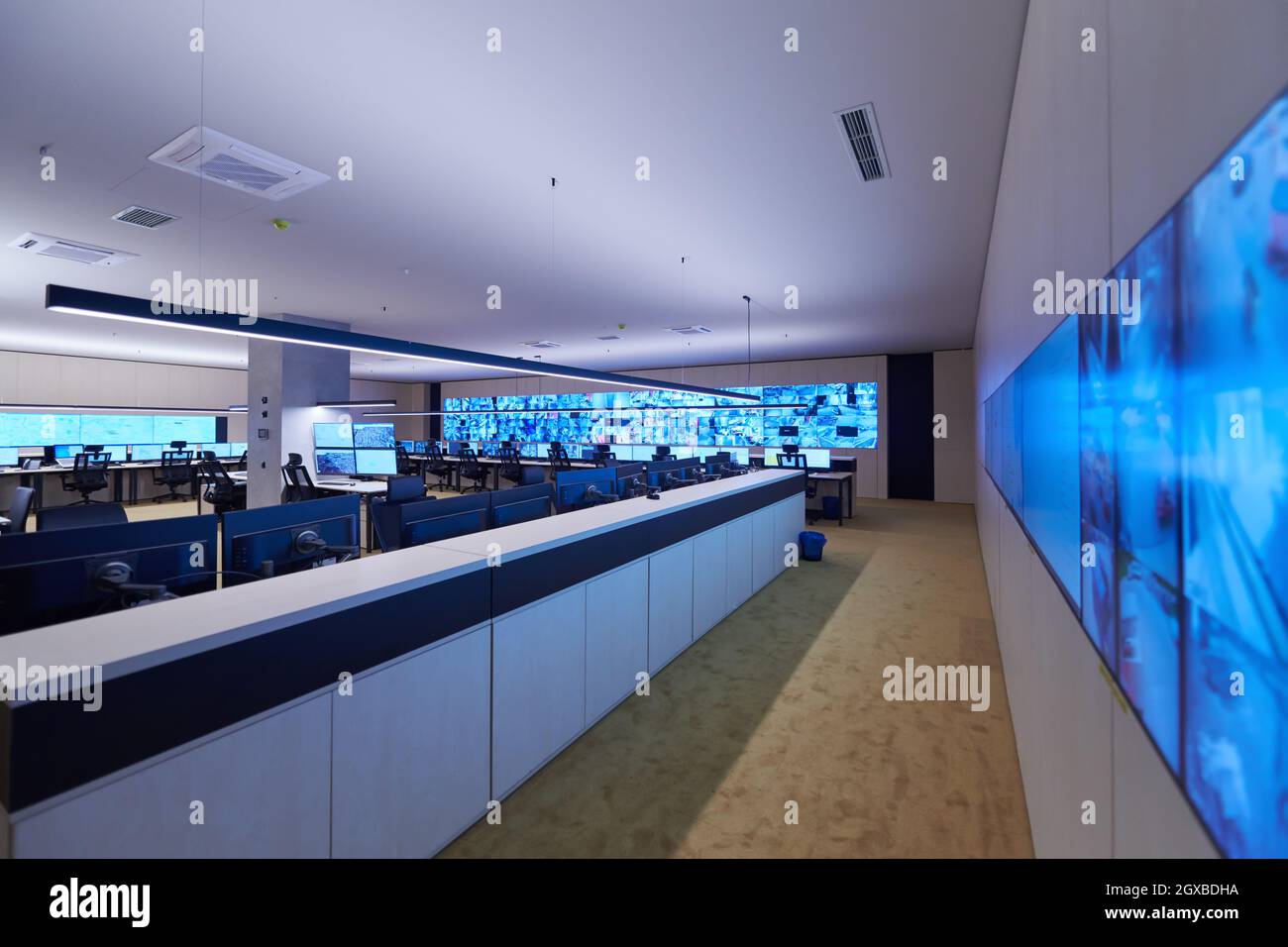 Empty interior of big modern security system control room, workstation ...