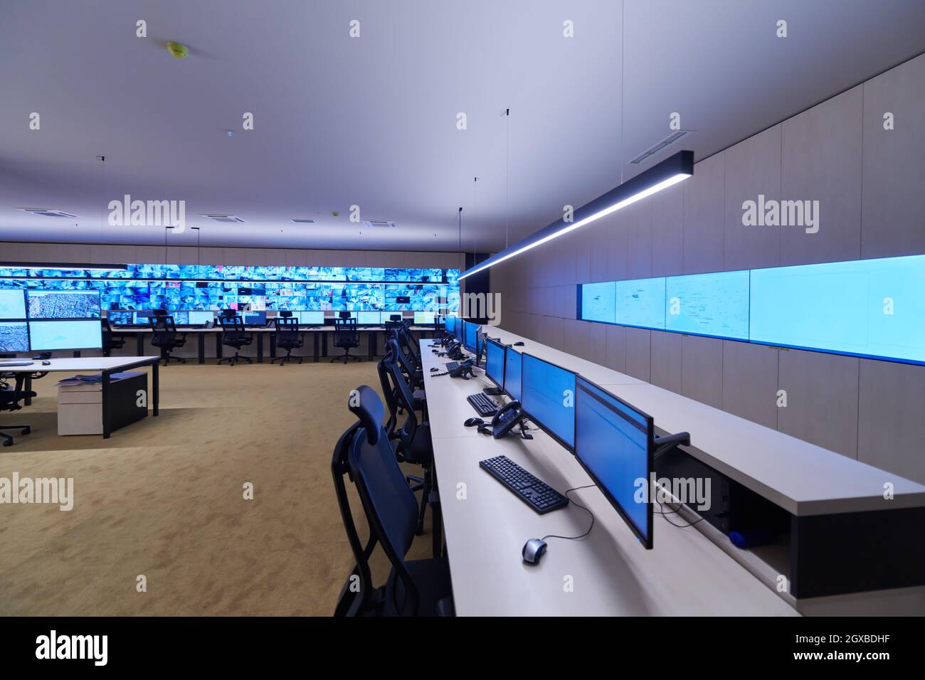 Empty interior of big modern security system control room, workstation ...