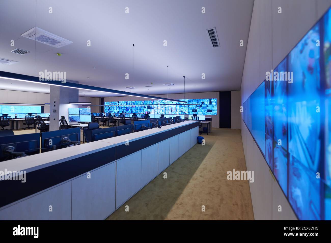 Empty interior of big modern security system control room, workstation ...
