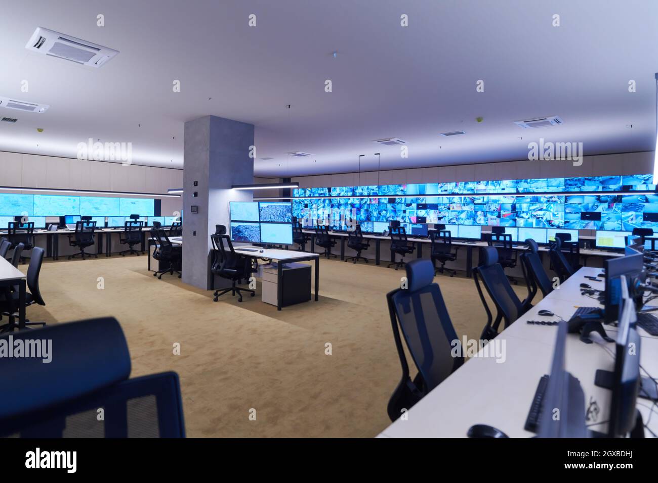 Empty interior of big modern security system control room, workstation ...