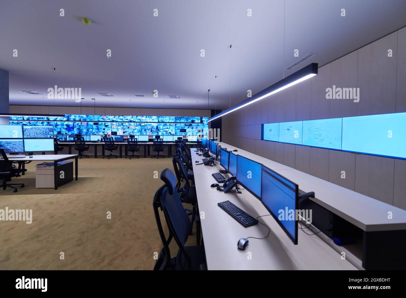 Empty interior of big modern security system control room, workstation ...