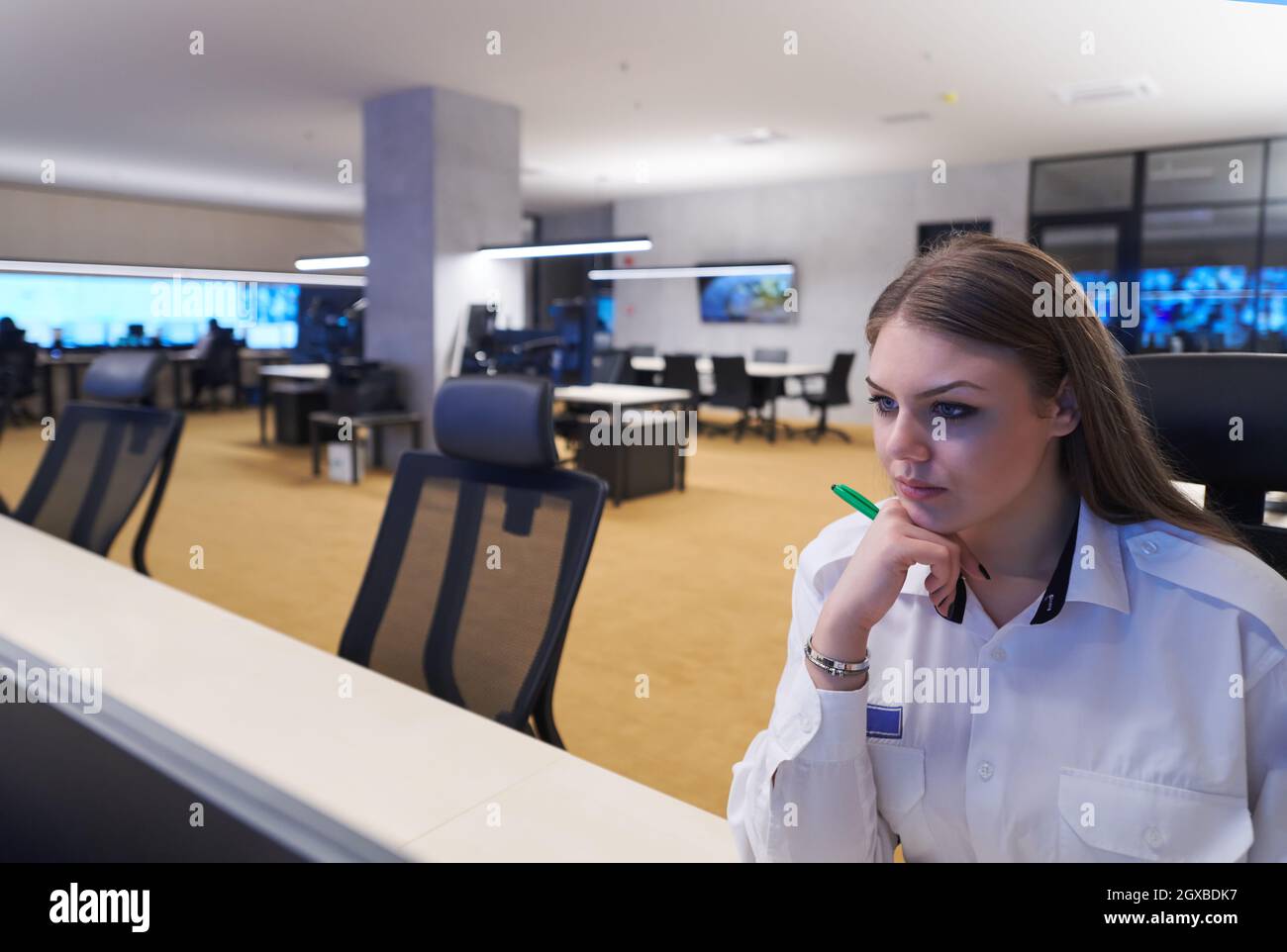 Female security operator working in a data system control room offices ...