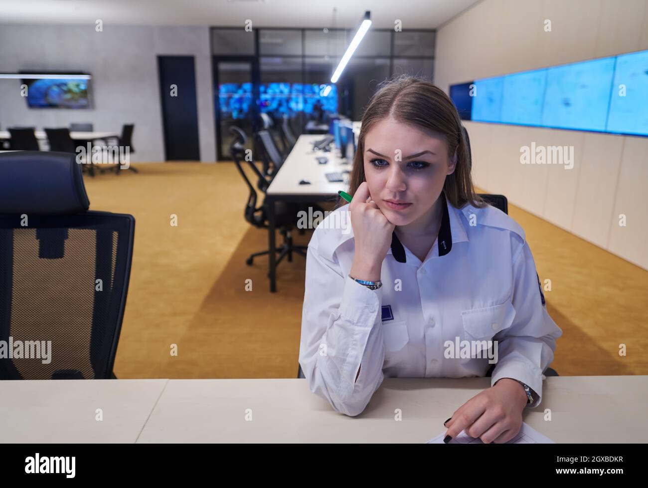 Female security operator working in a data system control room offices ...