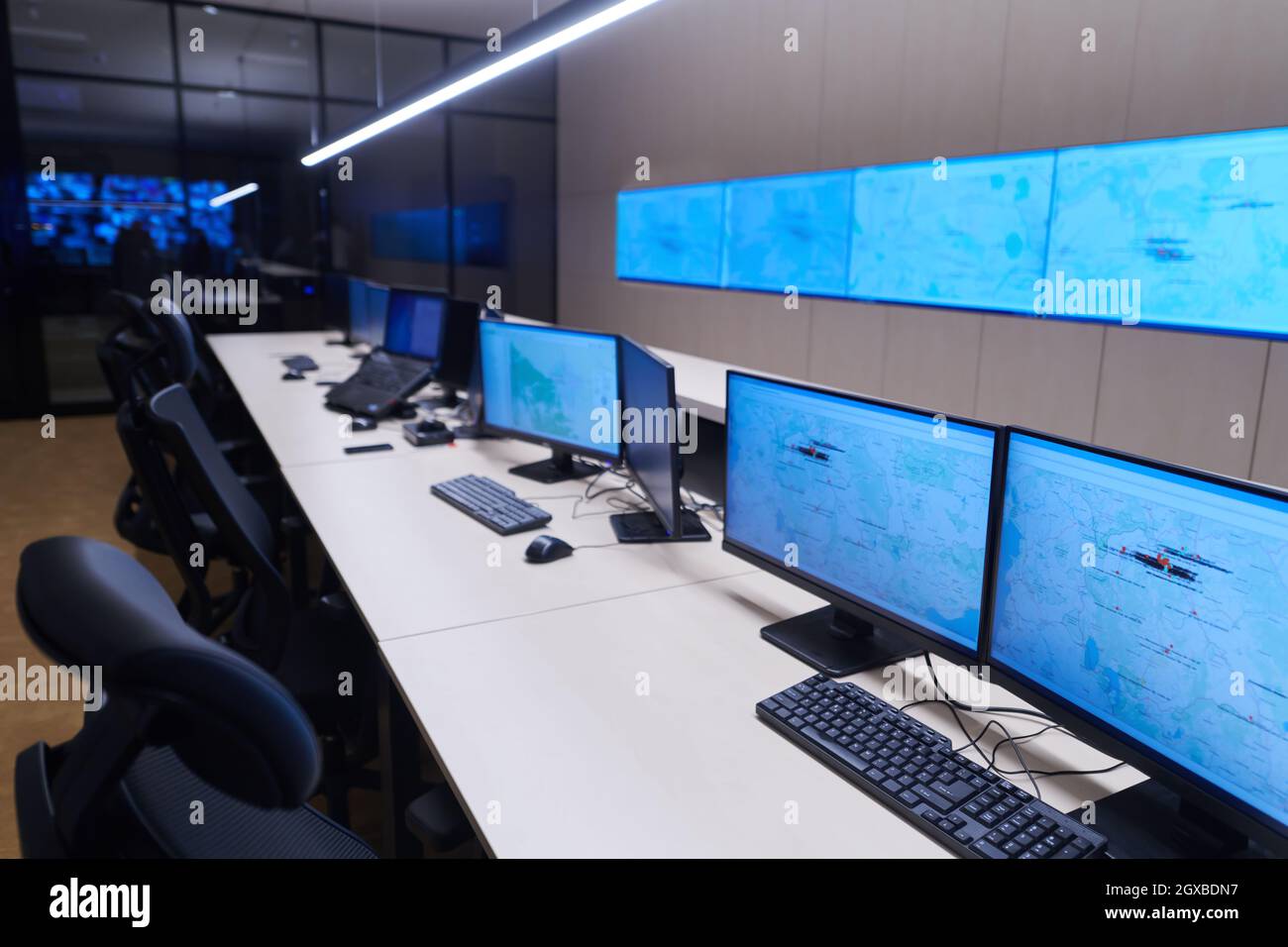 Empty interior of big modern security system control room, workstation ...