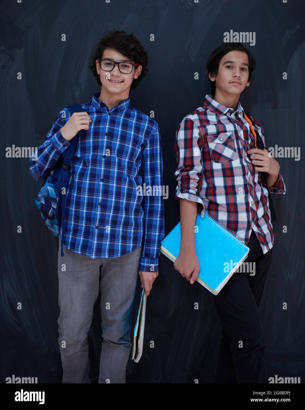 Arabic teenagers group portrait against black chalkboard wearing ...